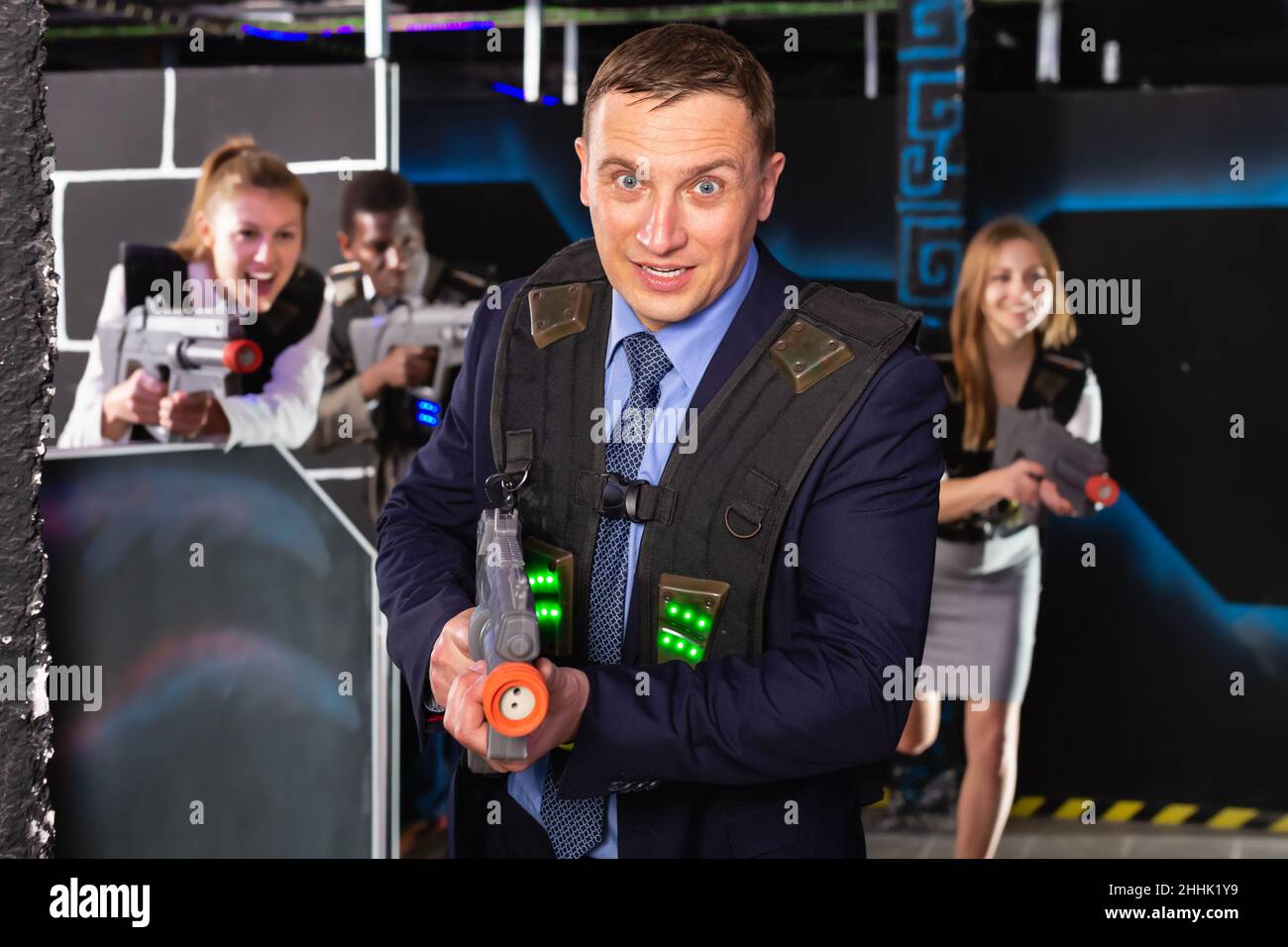 Man holding laser gun and playing laser tag Stock Photo - Alamy