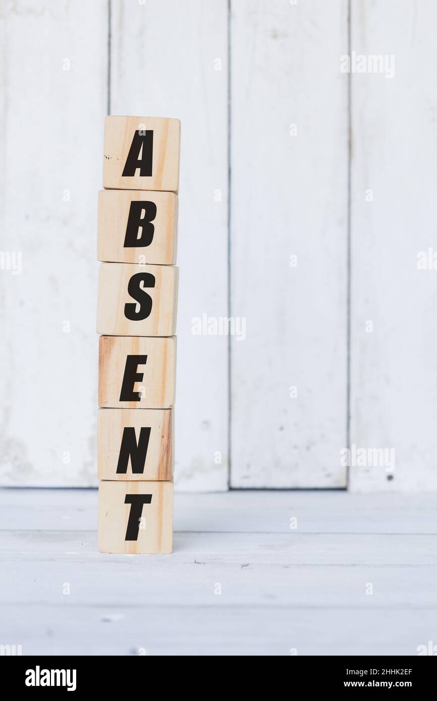 wooden cube with the word absent, on white wooden background Stock ...