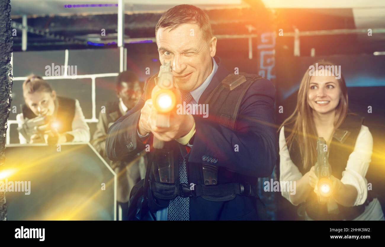 Man holding laser gun and playing laser tag Stock Photo - Alamy