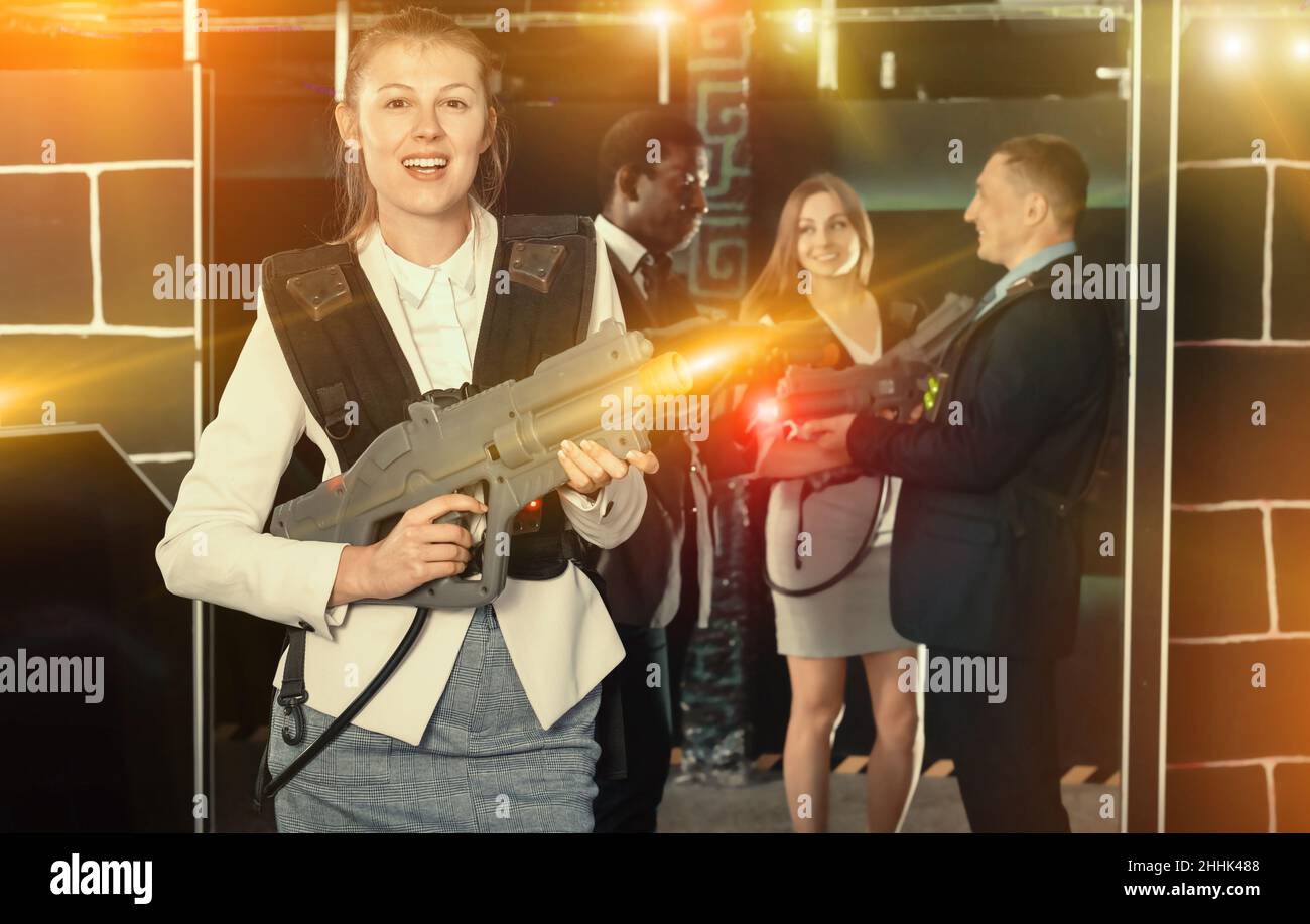 Woman holding laser gun and playing laser tag Stock Photo - Alamy