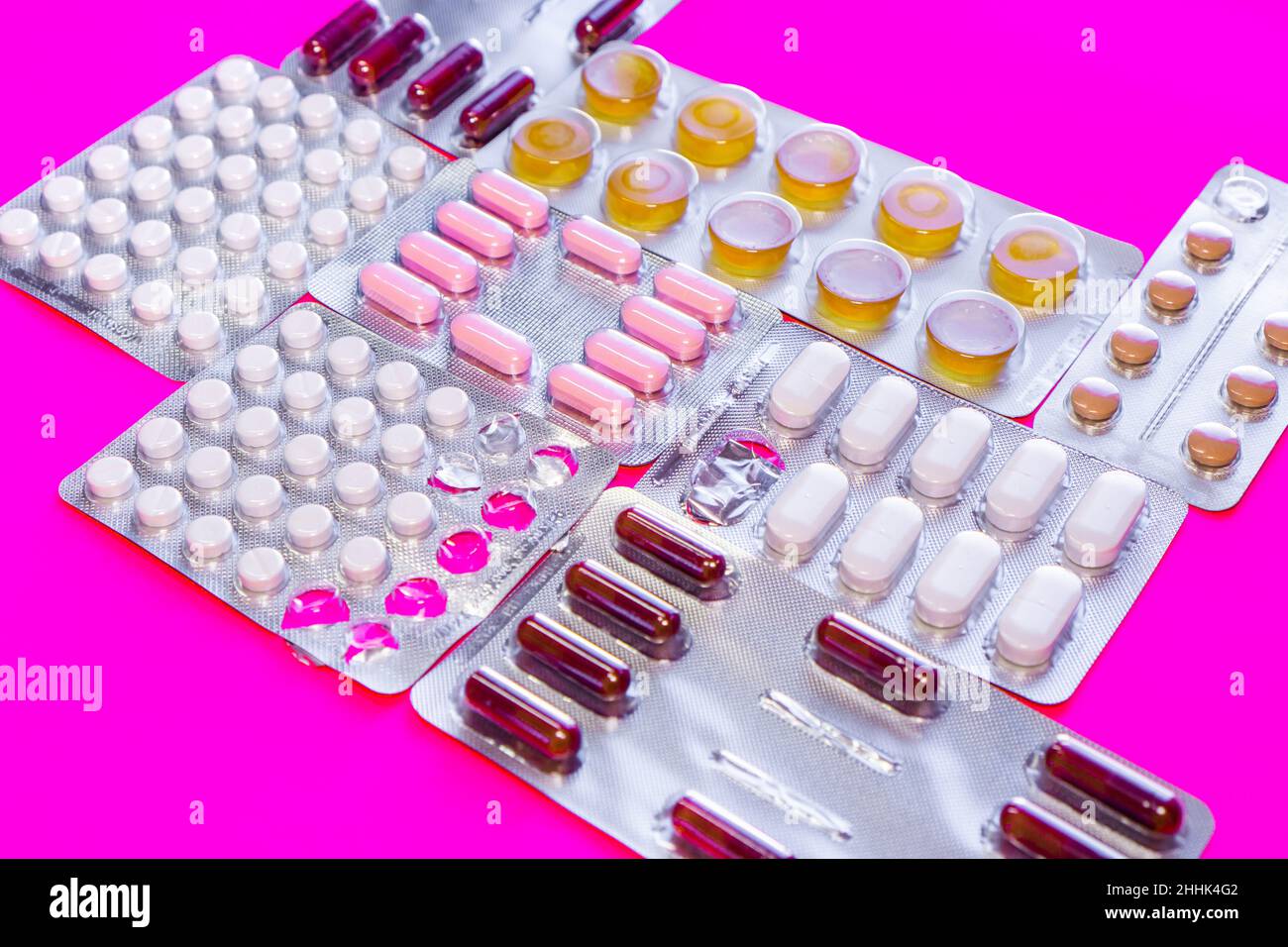 Different and colorful pill blisters on vivid pink background Stock ...