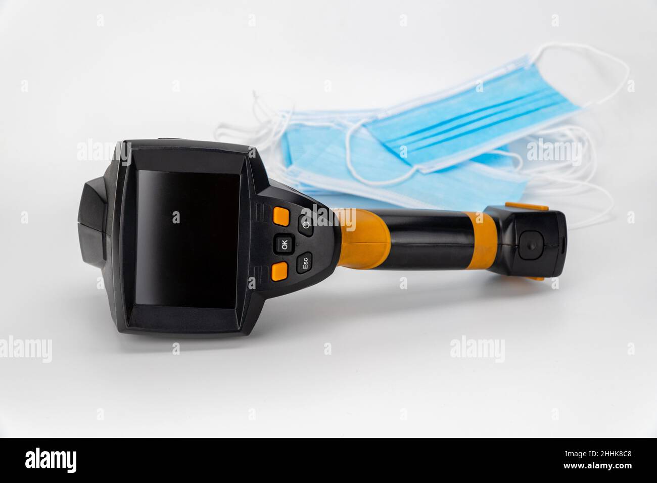 thermal imager and medical masks on a white background. temperature ...
