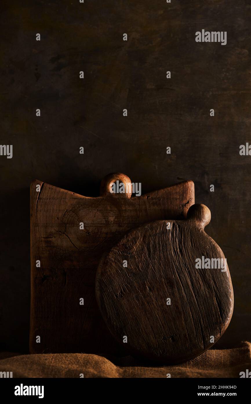Handmade wooden chopping board of brown color placed on rustic table ...