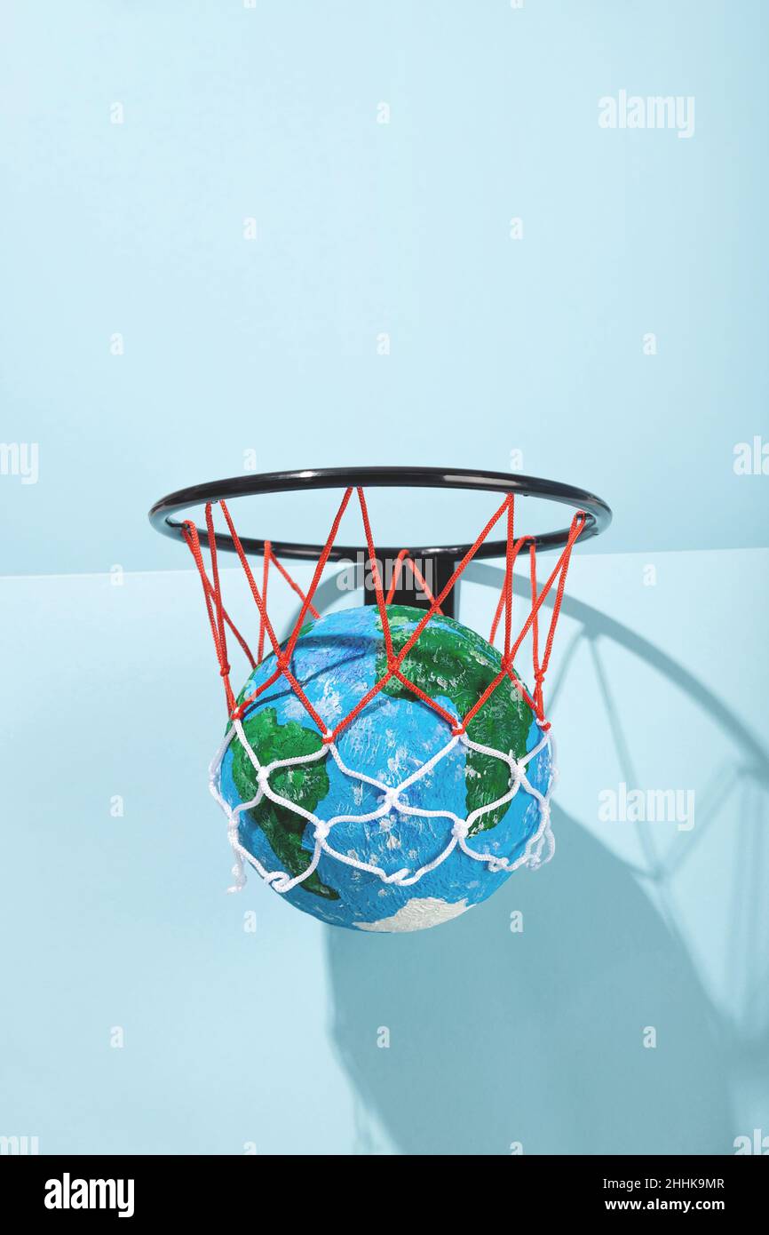 Round planet Earth with water and land in basketball hoop with colorful ...