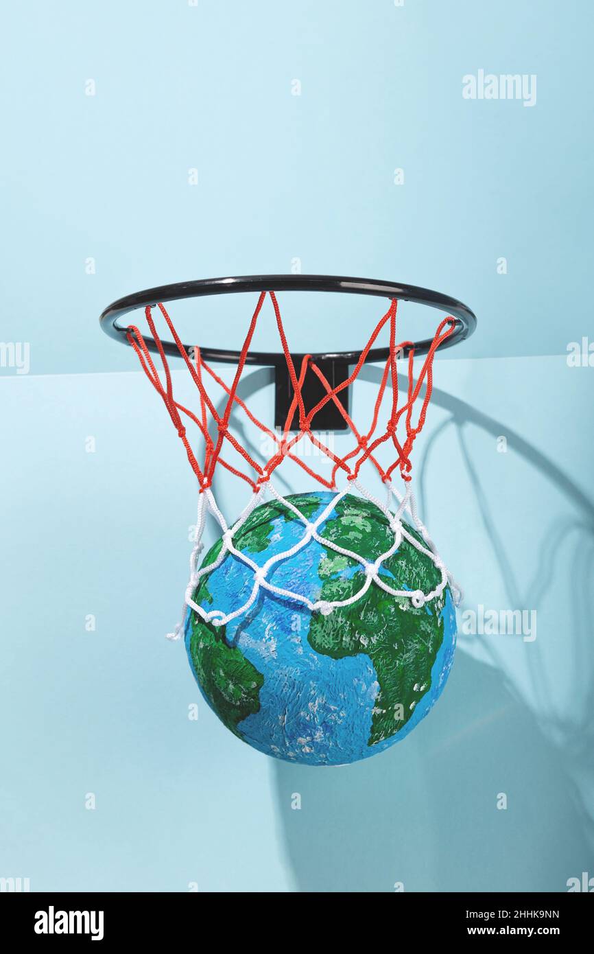 Round planet Earth with water and land in basketball hoop with colorful ...