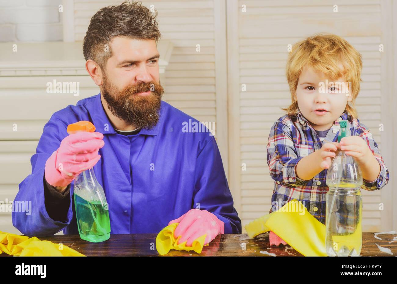 Dad and kid having fun during cleaning. Man with child plays with ...