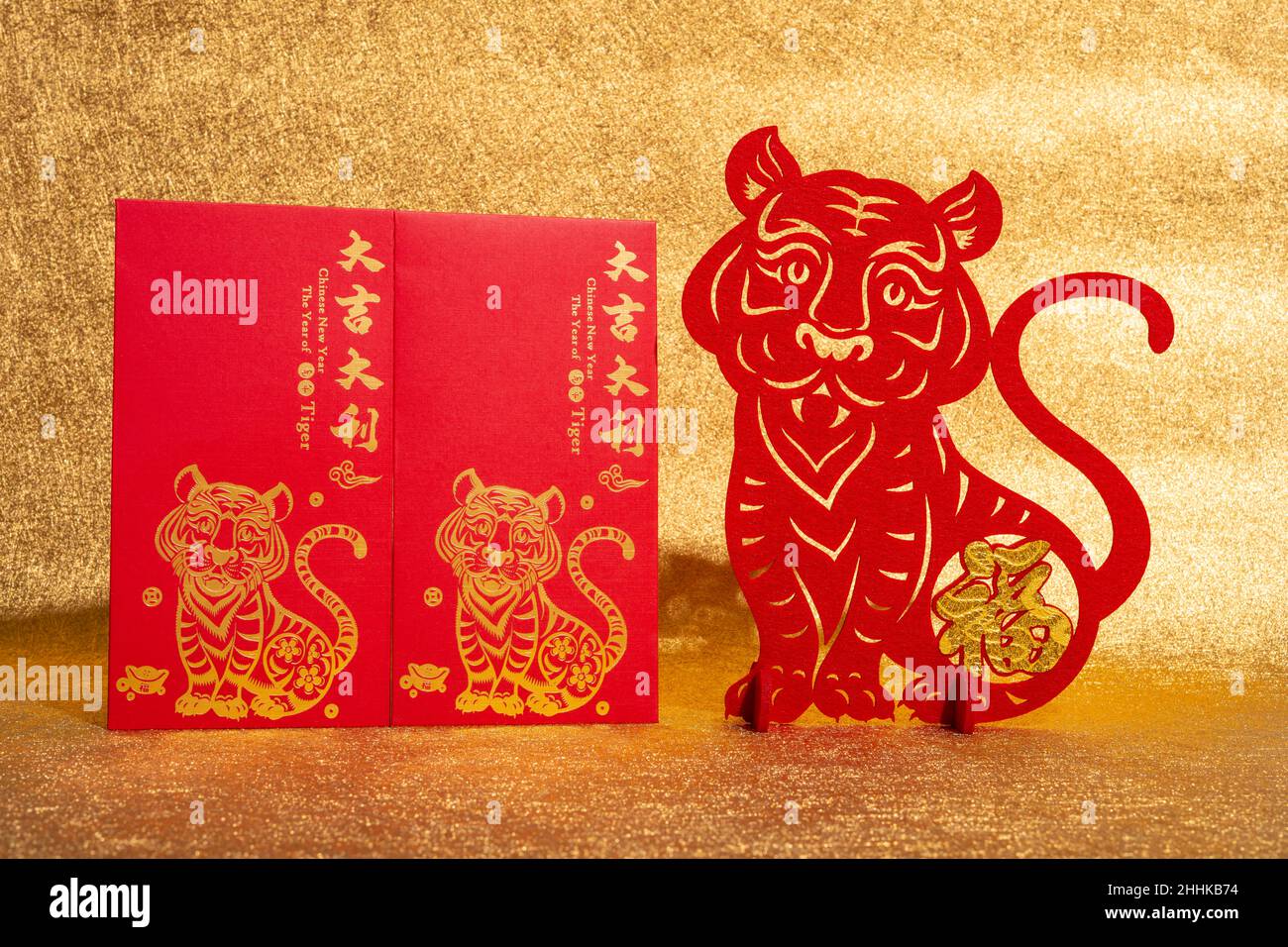 Chinese New Year of Tiger mascot paper cut and red pockets the Chinese ...