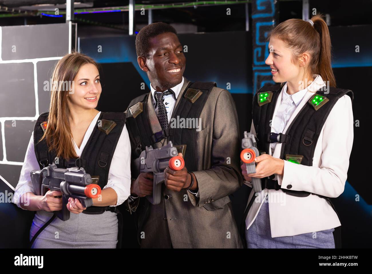 African man and two nice women at laser tag room Stock Photo - Alamy