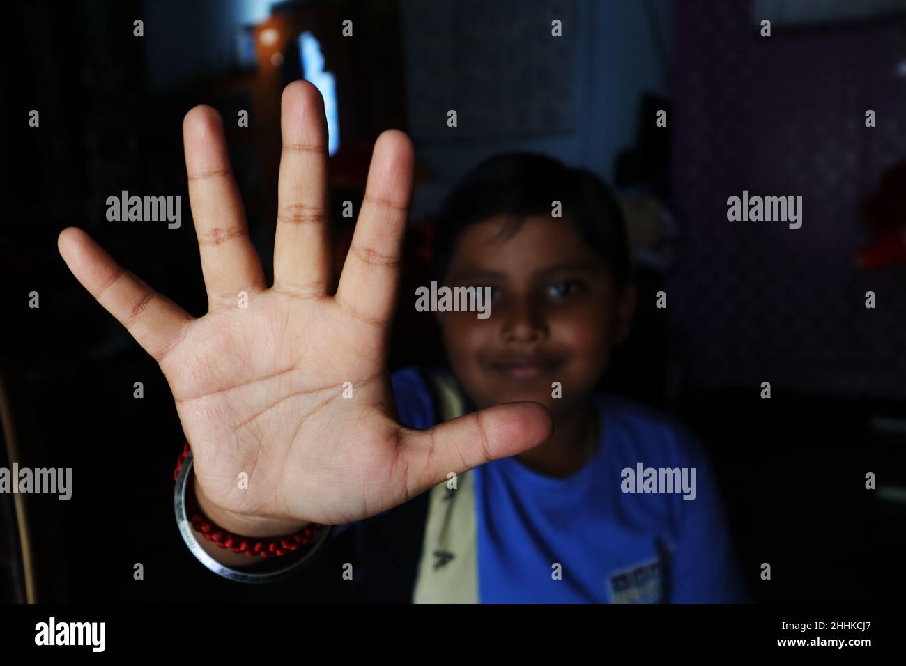 A kid showing five fingers and hand with a smiling face Stock Photo - Alamy