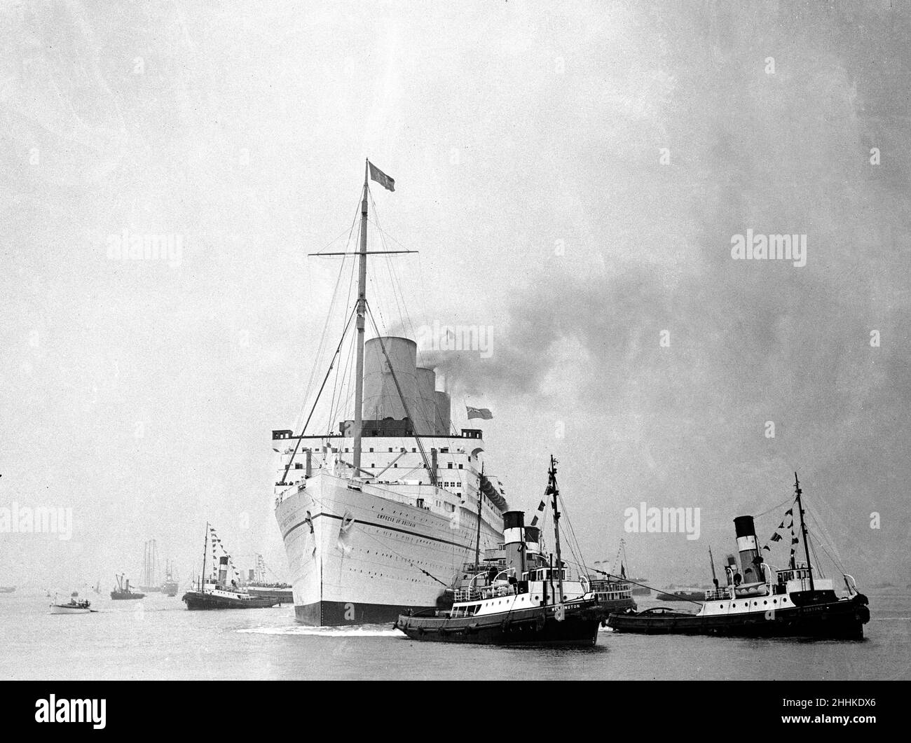 The Canadian Pacific ocean liner Empress of Britain with tug boats ...