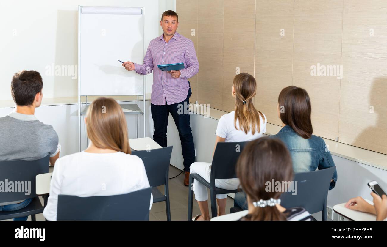 Business coach communicating with auditorium Stock Photo - Alamy