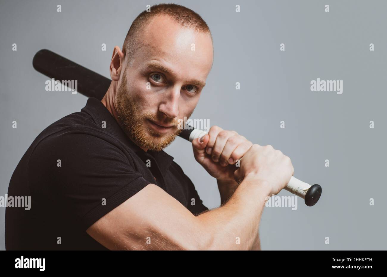 Guy with baseball bat for fighting. Dangerous man with serious emotion ...
