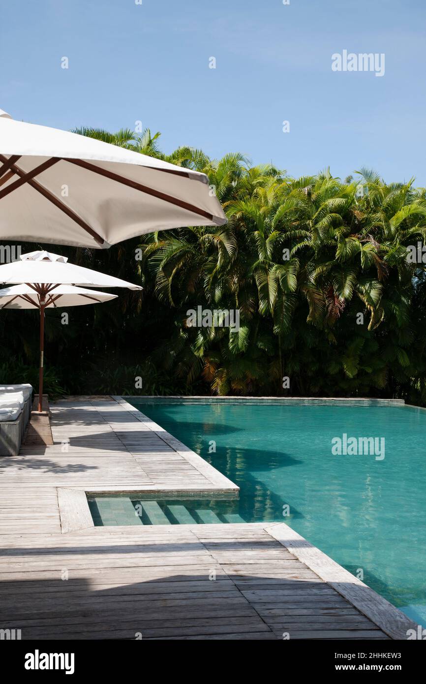 Cambodia, Hotel swimming pool with umbrellas Stock Photo - Alamy