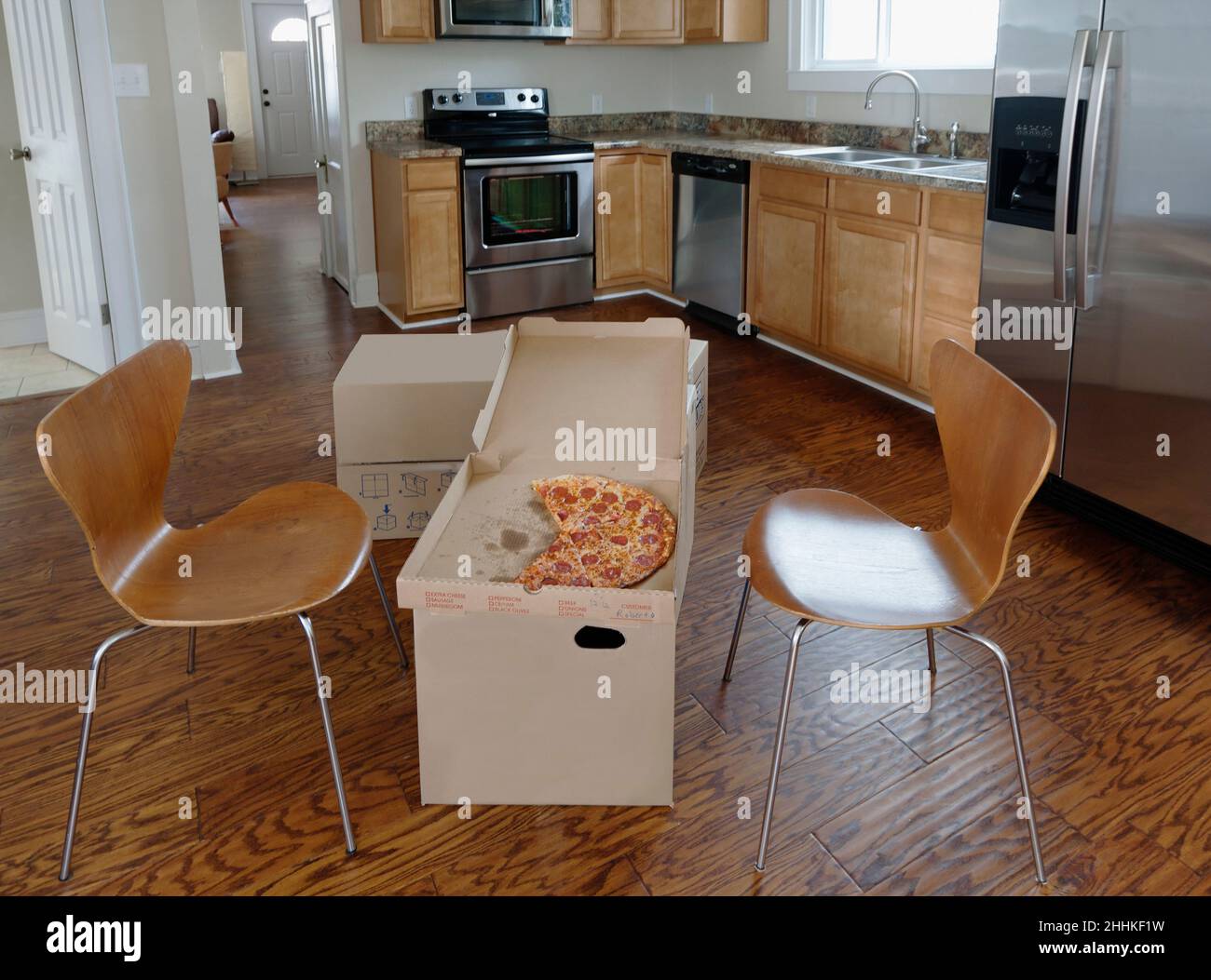 Pizza break on cardboard boxes during house move Stock Photo - Alamy