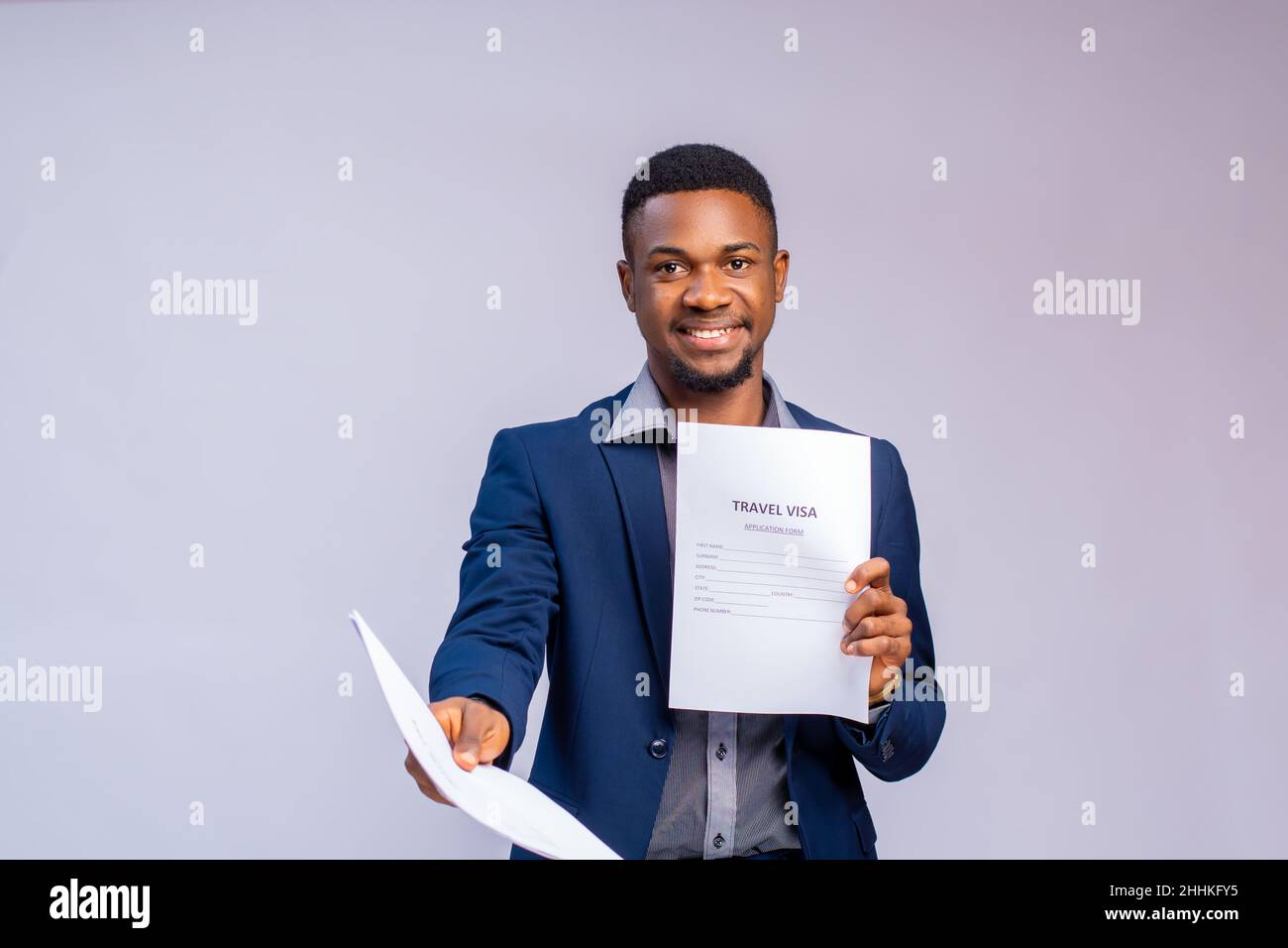 close up of a handsome african black travel agent holding travel visa ...