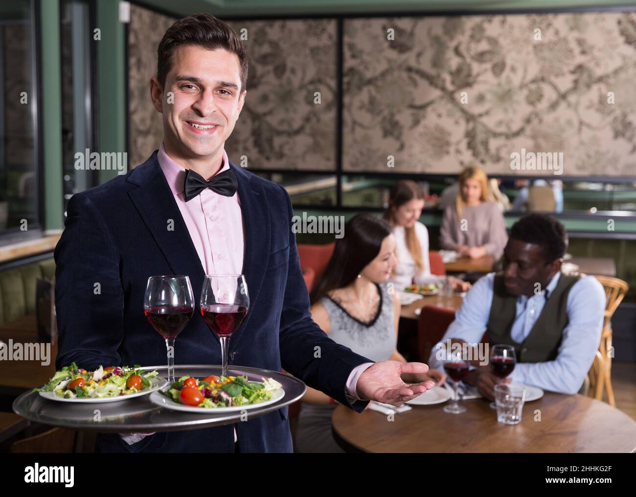 Elegant waiter with serving tray Stock Photo - Alamy