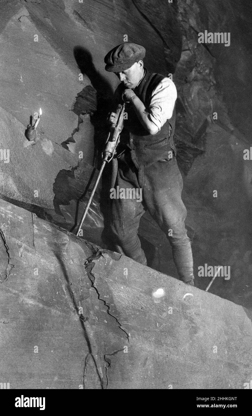 Drilling the huge mountains of slate in the mine, half a mile under the ...