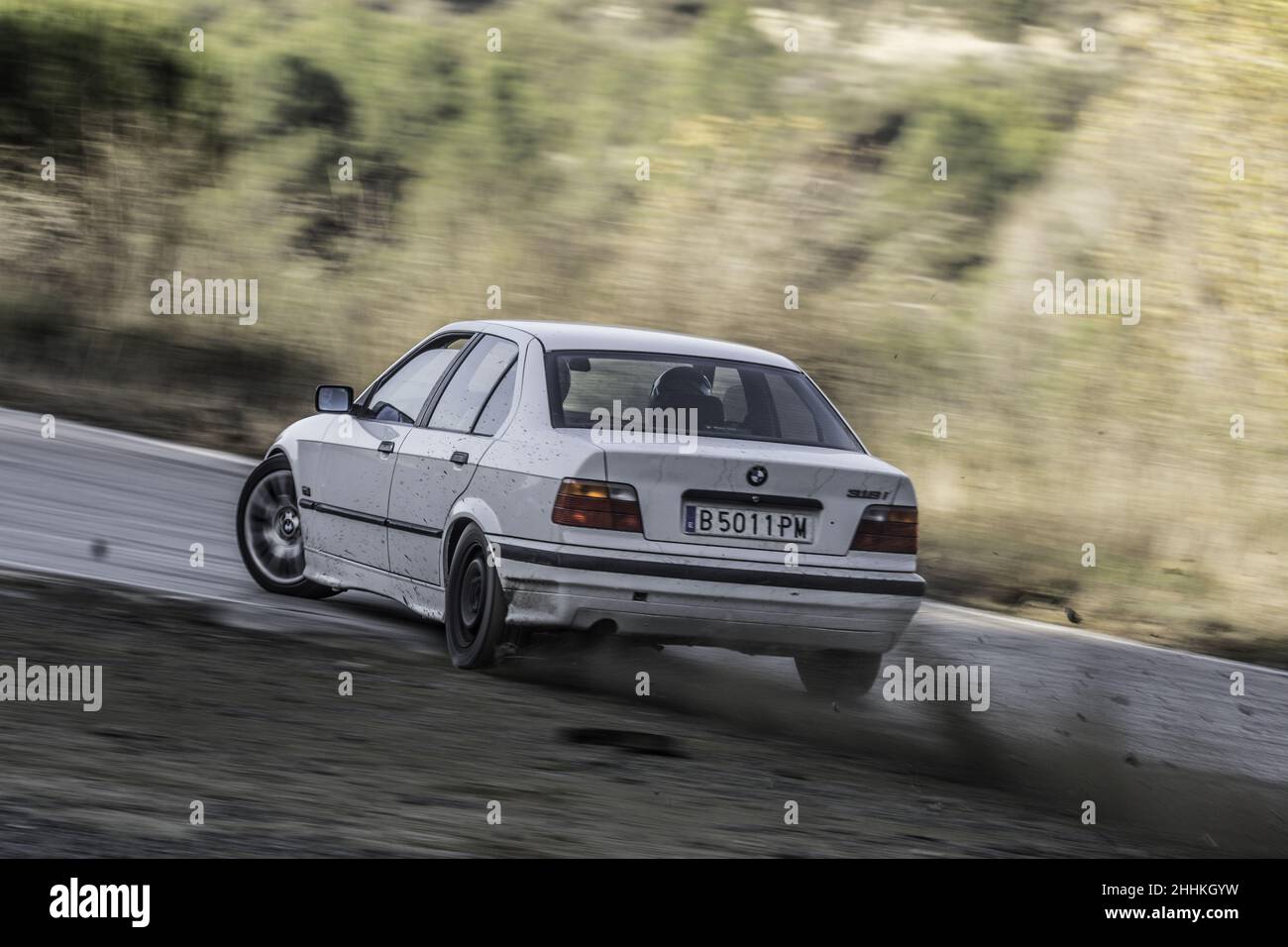 A cool modified BMW E36 racing on the road during a competition in ...