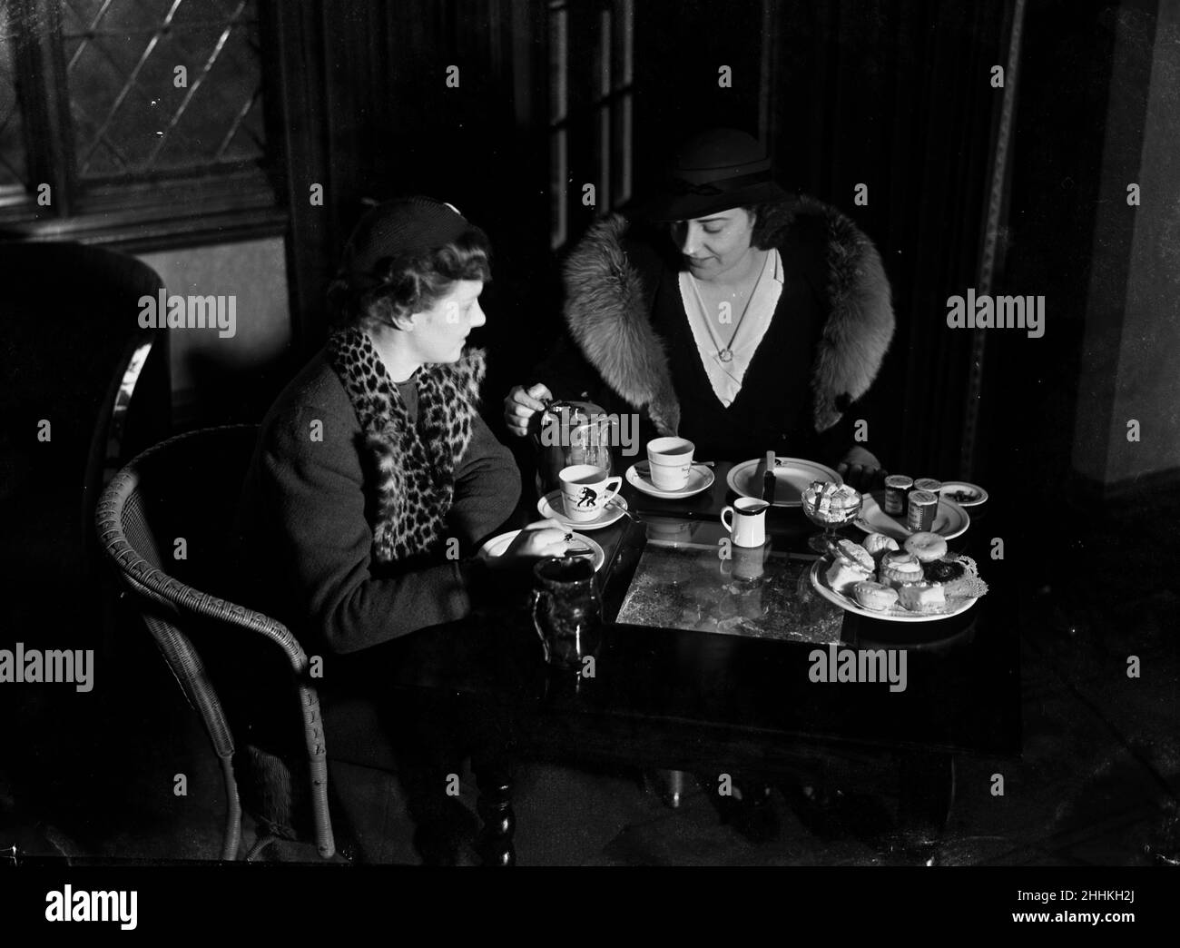 Two ladies taking afternoon tea. c.1930 Stock Photo - Alamy