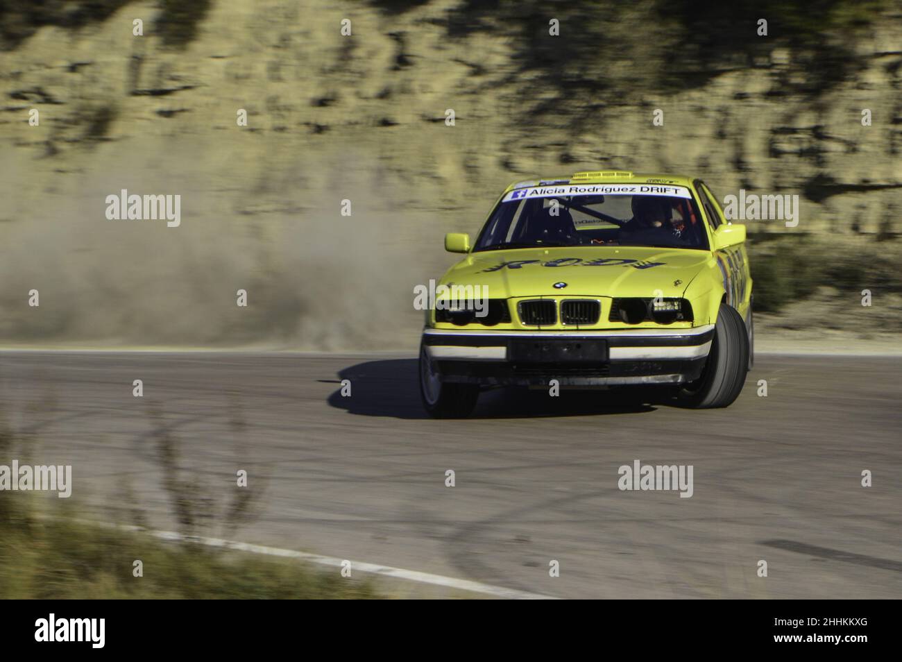 Modified yellow BMW E34 530i racing on the road during a competition in ...