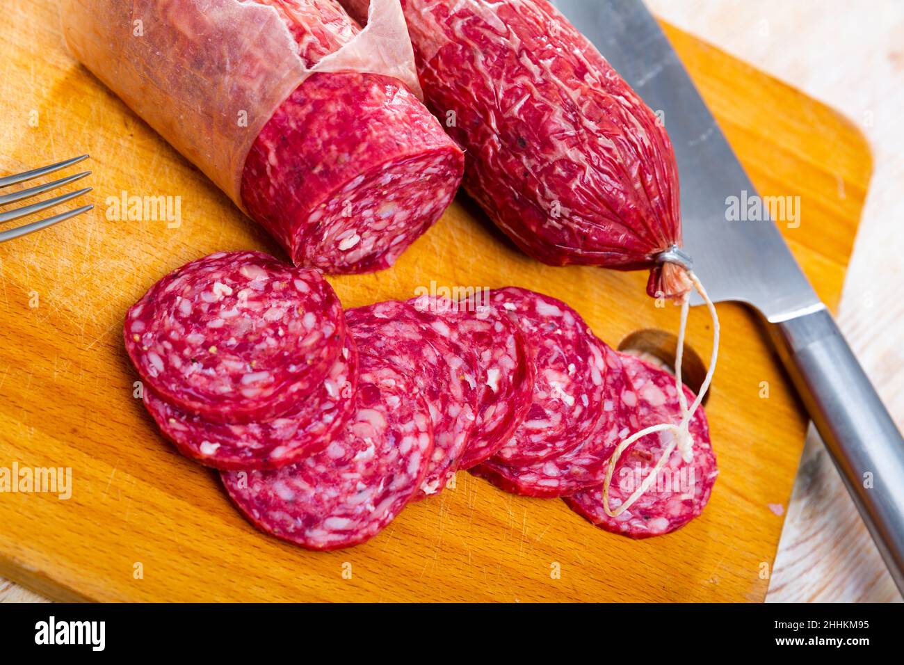 Slices of dry-cured sausage from Iberian pork seasoned with natural ...