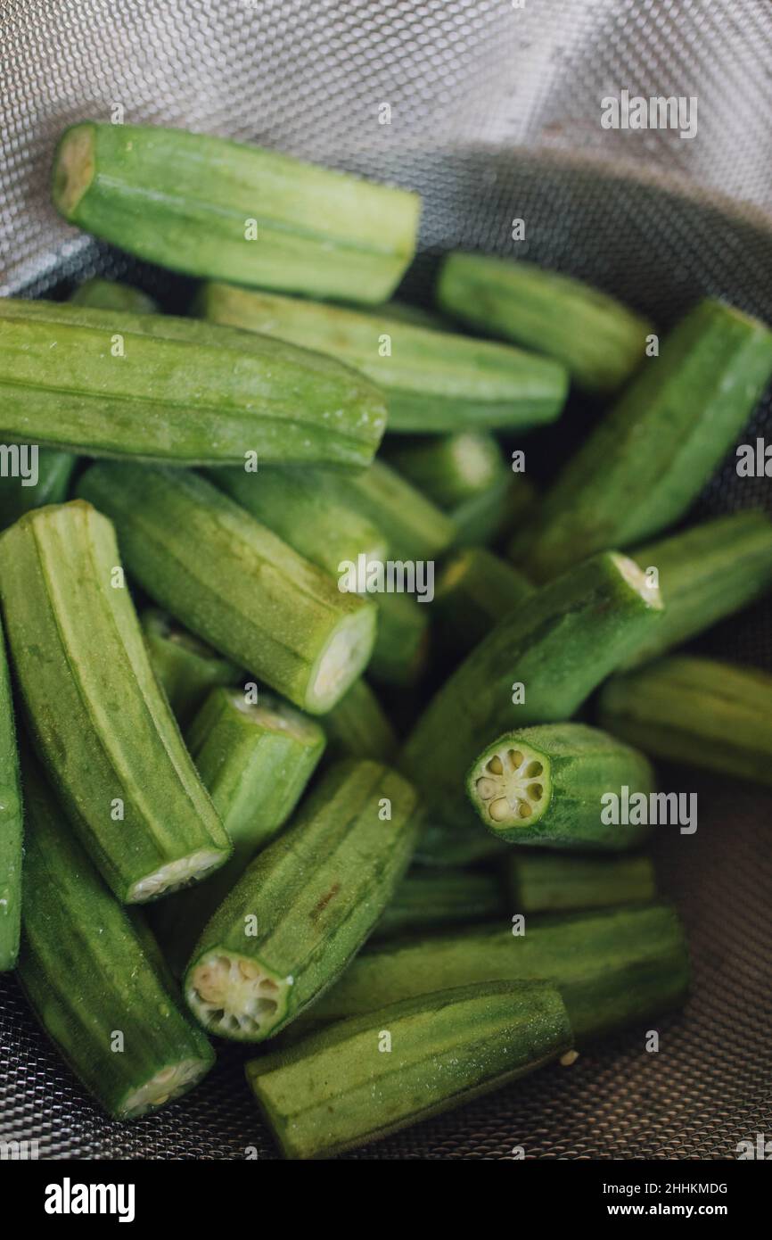 fresh, cut washed okra in mesh sieve strainer Stock Photo - Alamy
