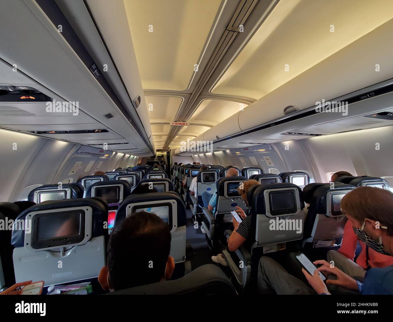 Wide angle of passengers aboard a United Airlines airplane during a ...