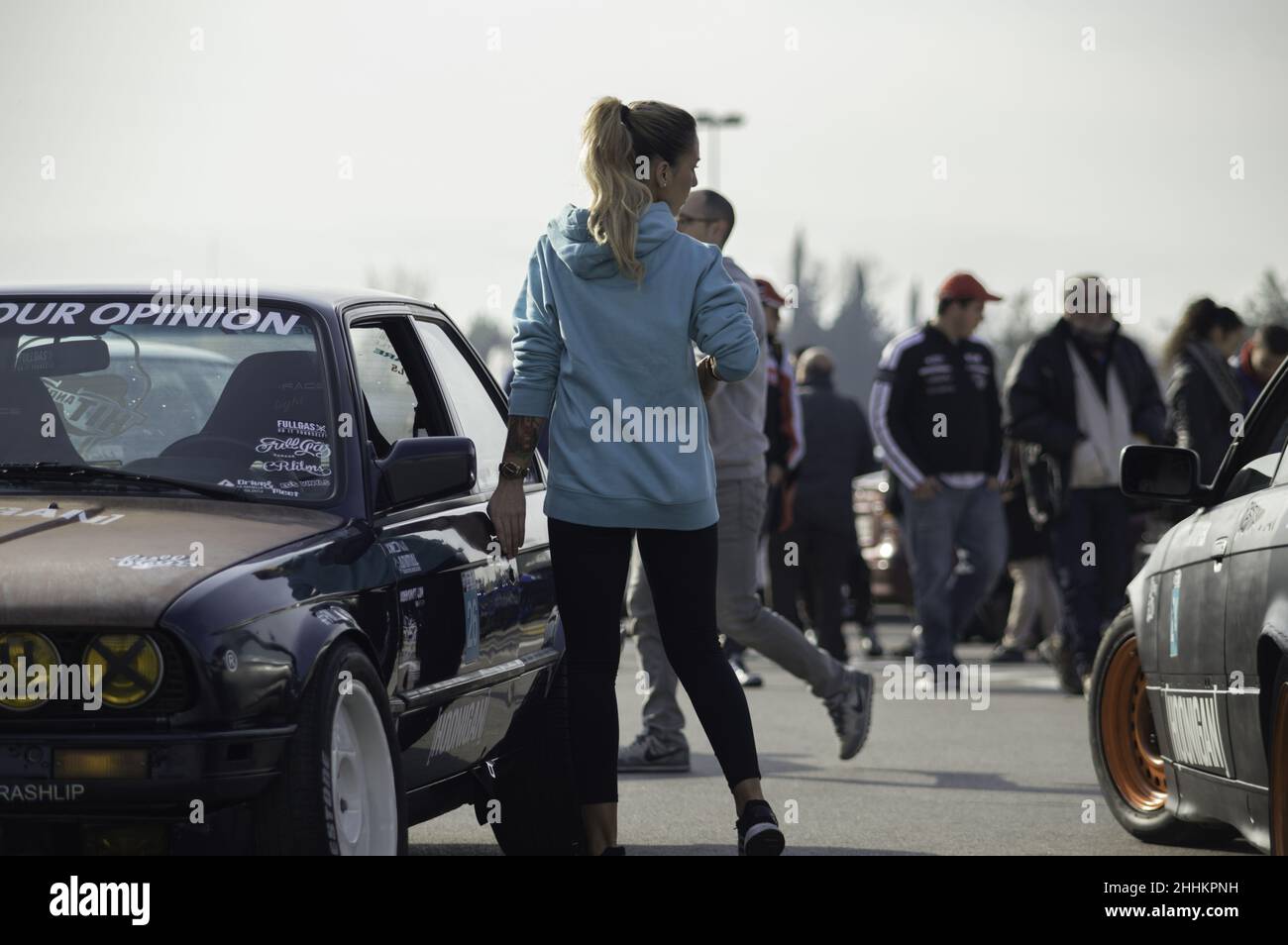 Young girl getting out of her nice classic BMW E30 tuned stance style ...