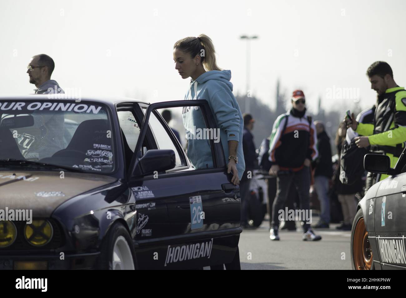 Young girl getting out of her nice classic BMW E30 tuned stance style ...