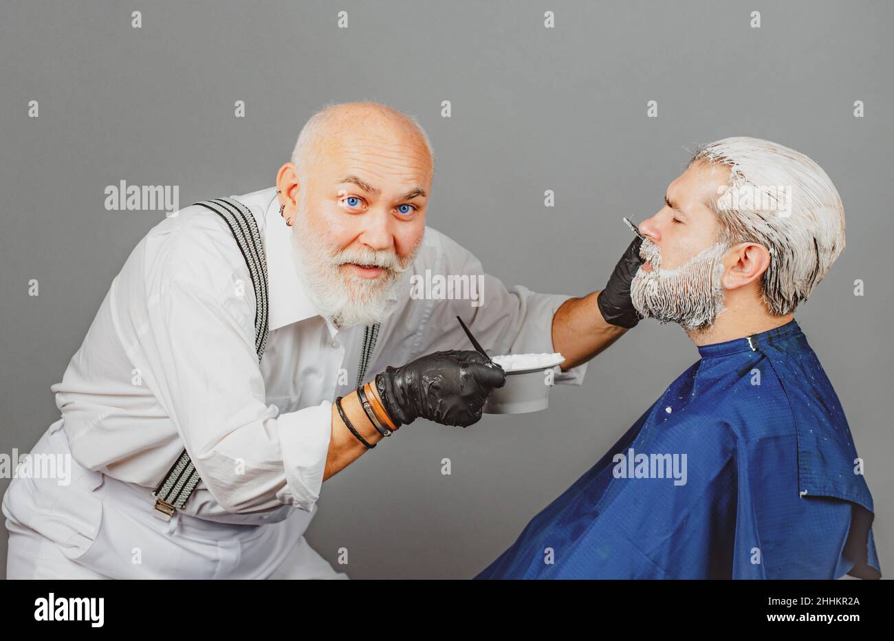 Hairdresser making of a color hair for hipster guy. Process of a man ...