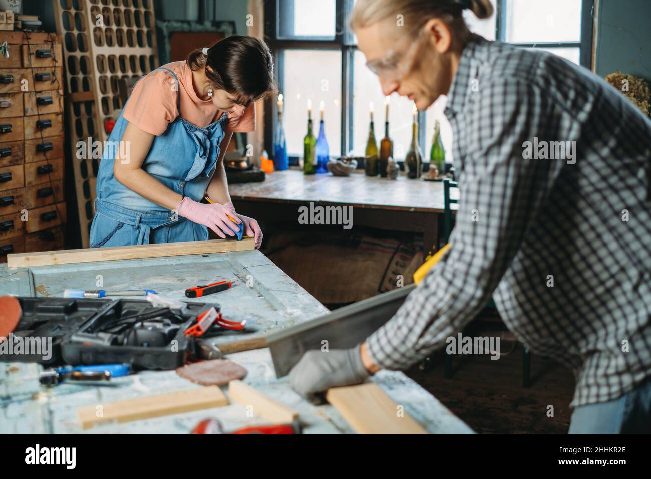 Man and woman working in workshop, doing furniture, reuse old materials ...