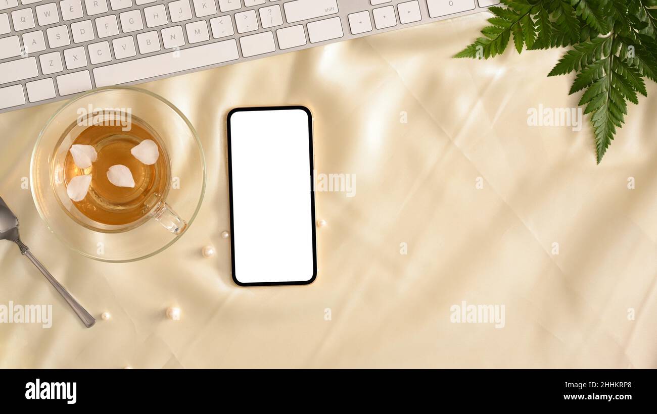 Female office desk with keyboard, teacup, decor, smartphone blank ...