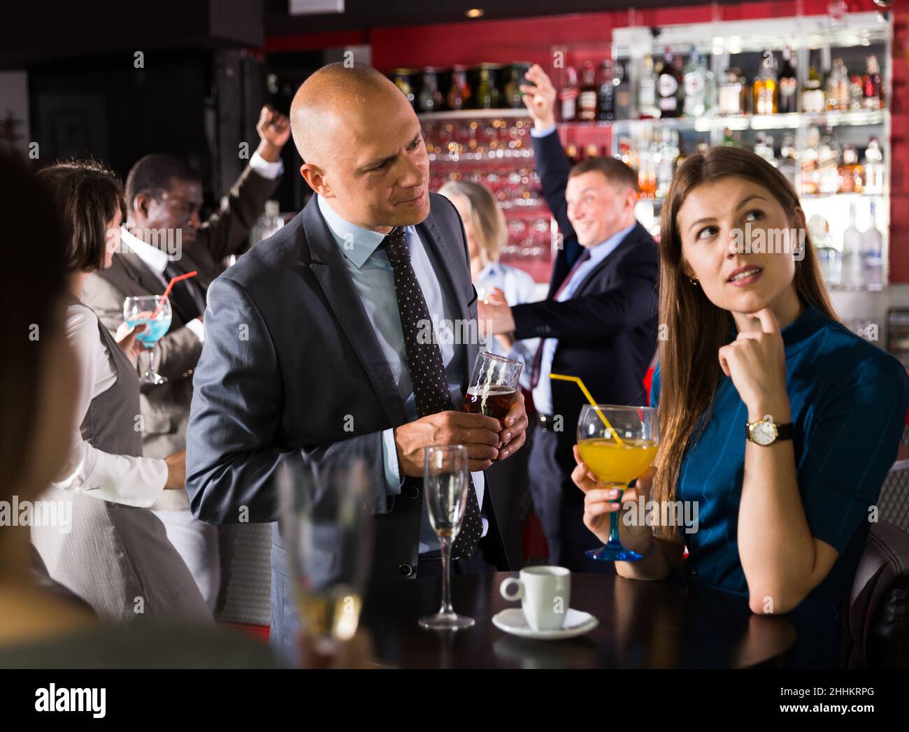 Man enjoying conversation with female colleague Stock Photo - Alamy