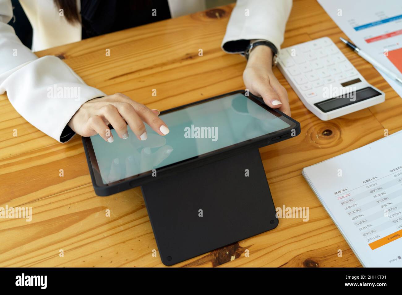 Top view, A female accountant using portable wireless tablet computer ...