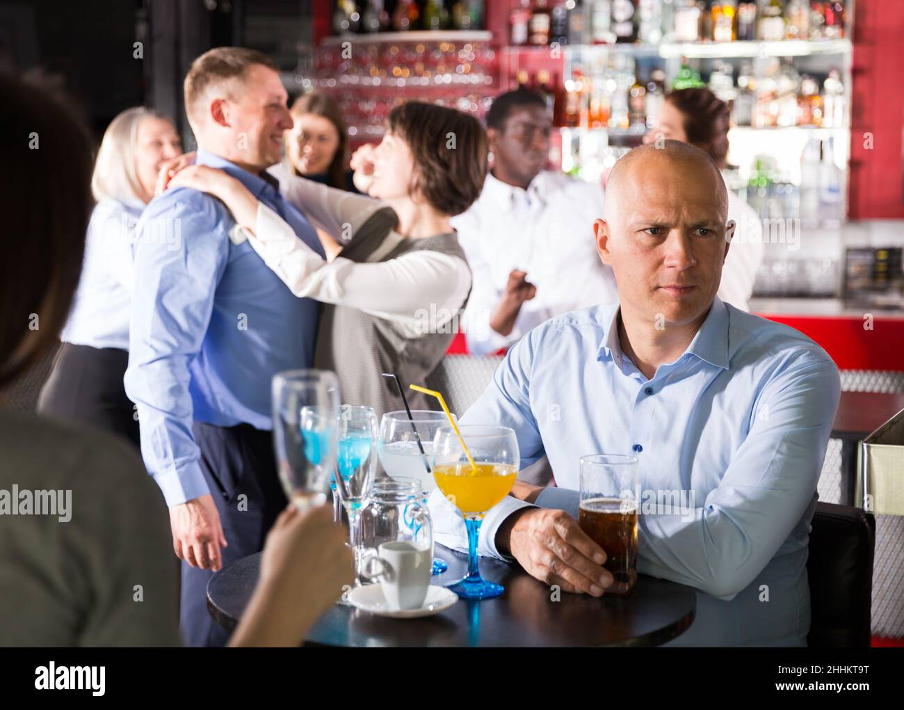 Worried businessman at corporate party Stock Photo - Alamy