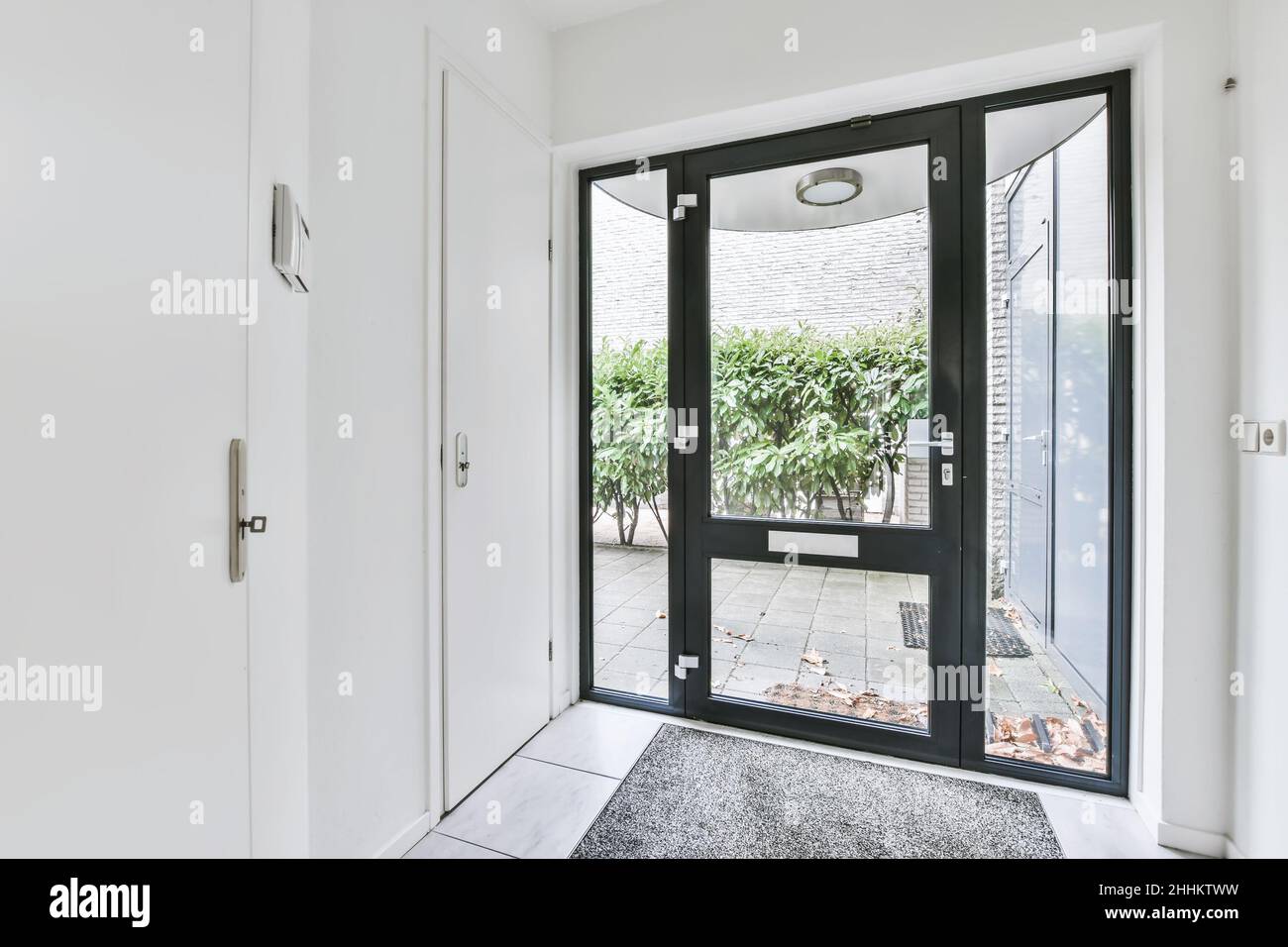 Cute design of the entrance to the house with a glass door Stock Photo ...