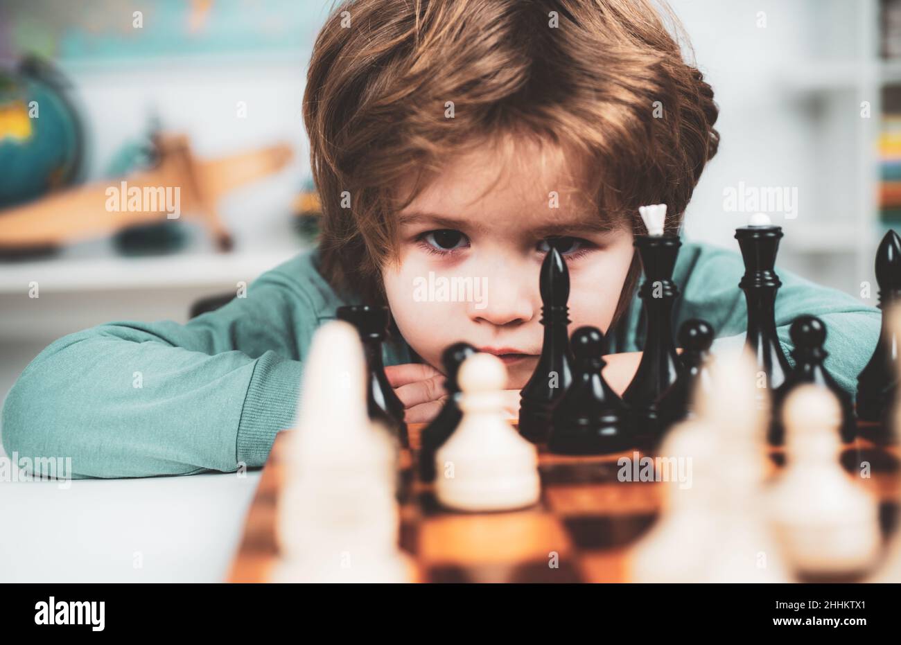 Little boy playing chess. Kids educational games, child early ...