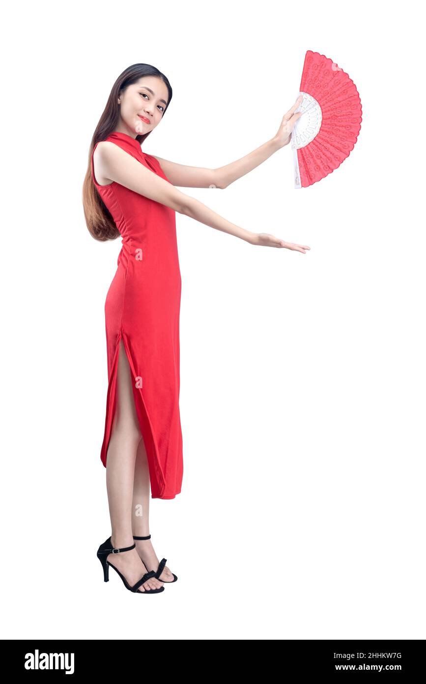 Asian Chinese woman in a cheongsam dress holding fan with open palm ...
