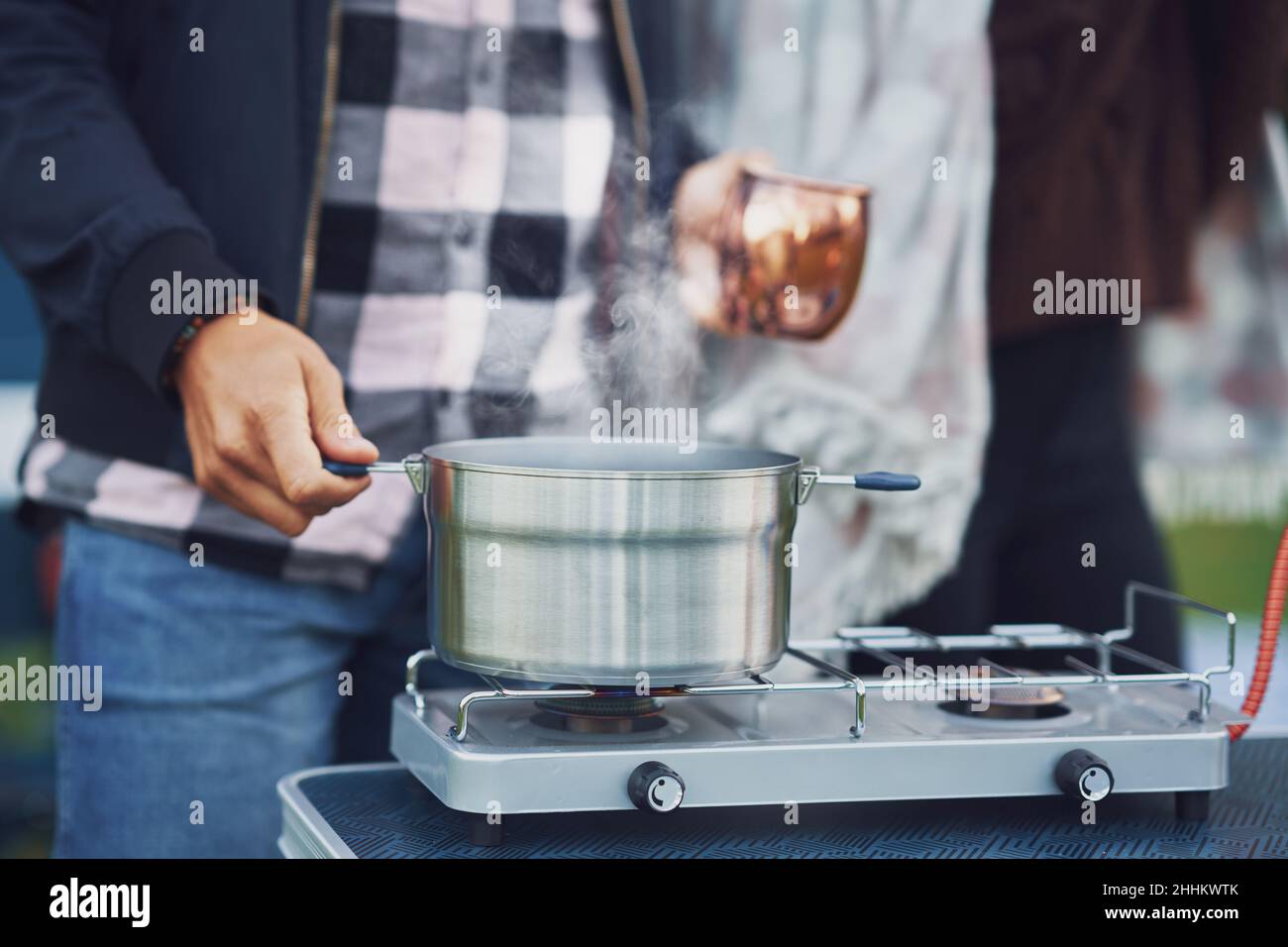 Young nice couple having fun on camping while cooking and eating Stock ...