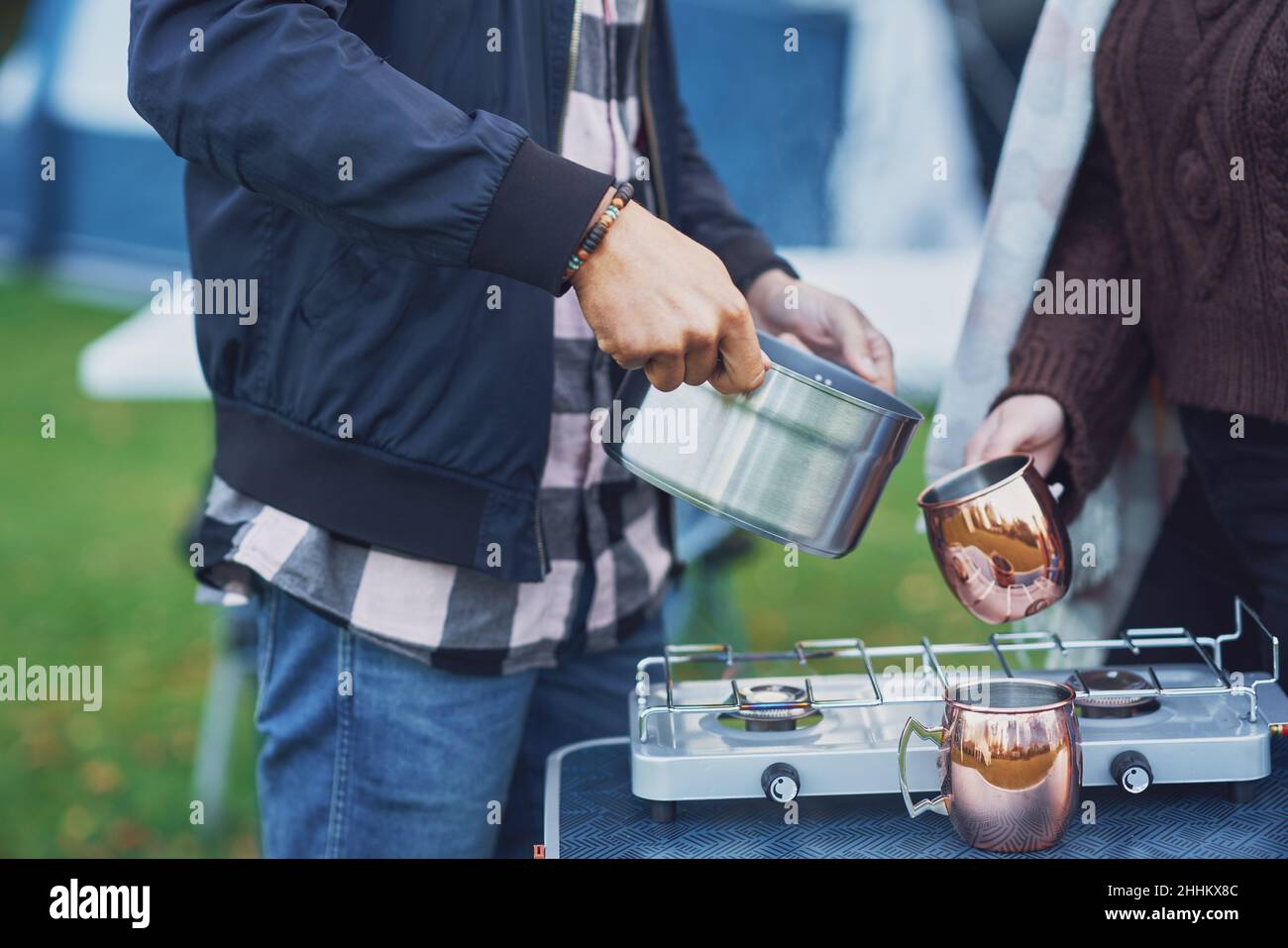 Young nice couple having fun on camping while cooking and eating Stock ...