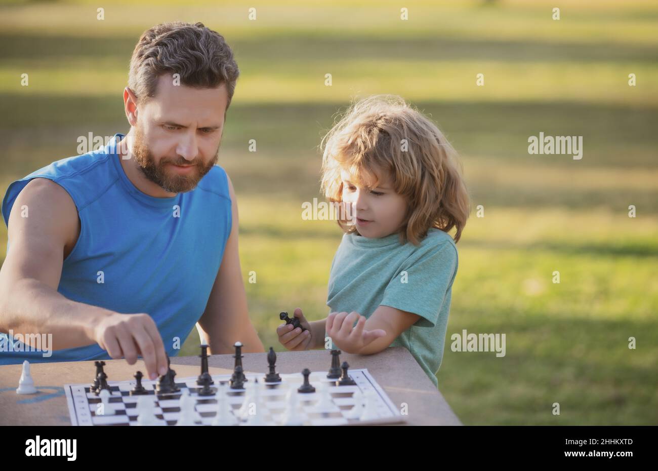 Father play chess with son. Family outside game. Games and activities ...