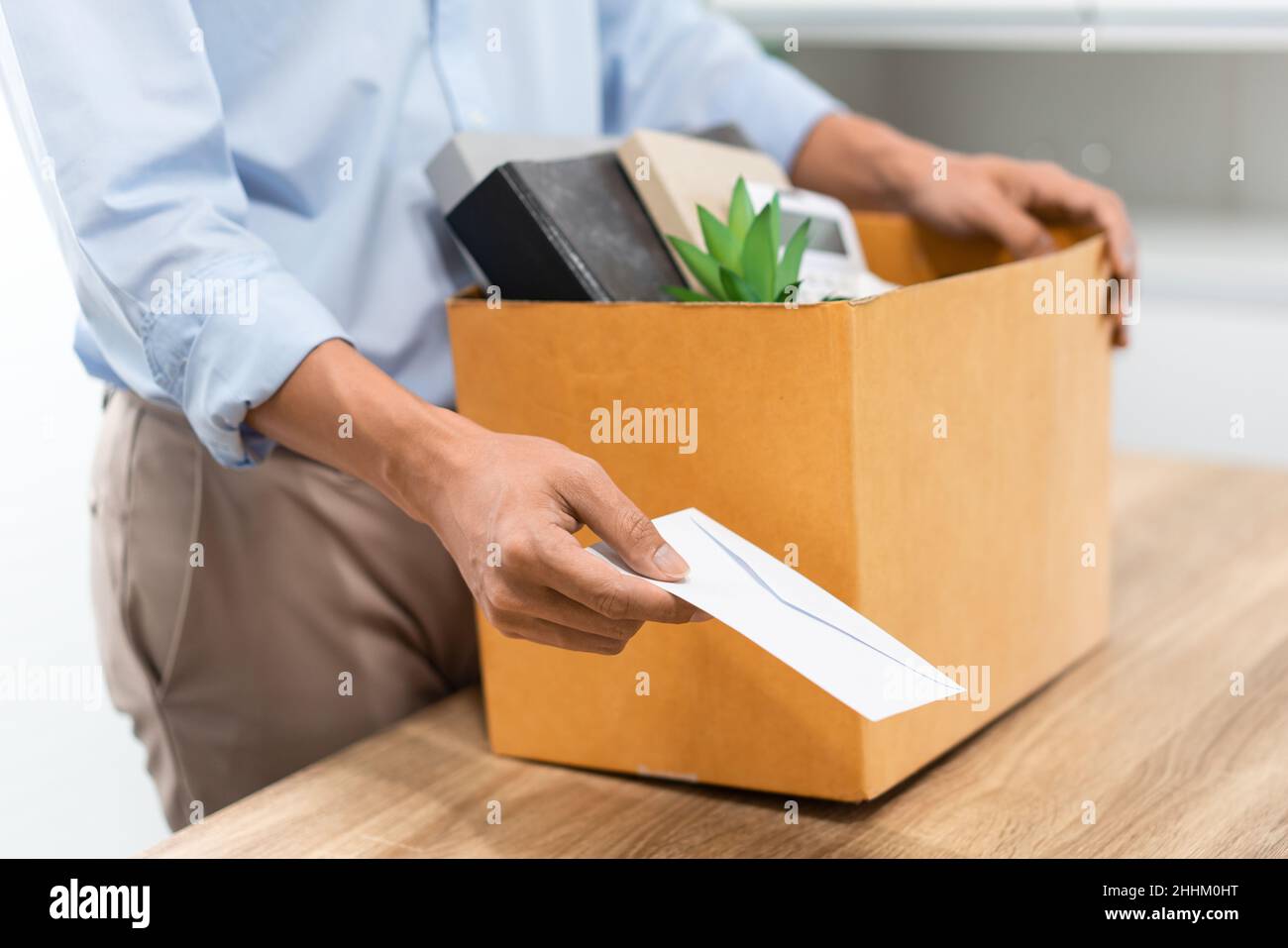 Resignation Concept The male officer standing, putting his box of his ...