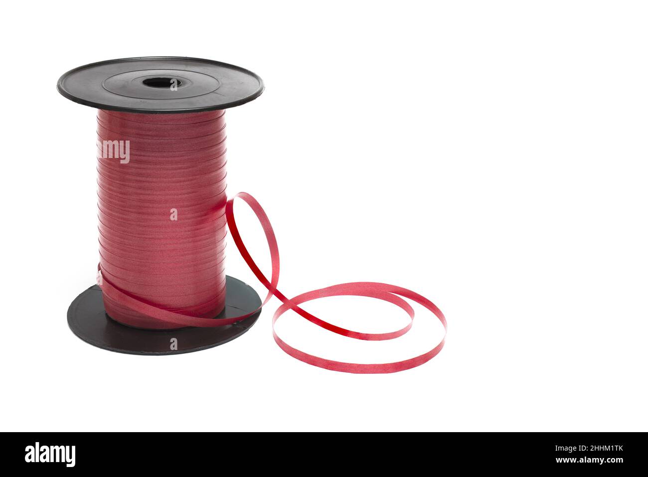 Close up of roll of red plastic ribbon band parcel tape for wrapping ...