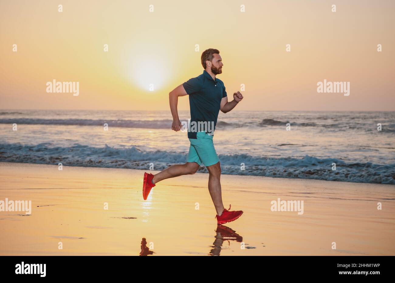 Sporty man runner running in summer. Man running on the beach at sunset ...
