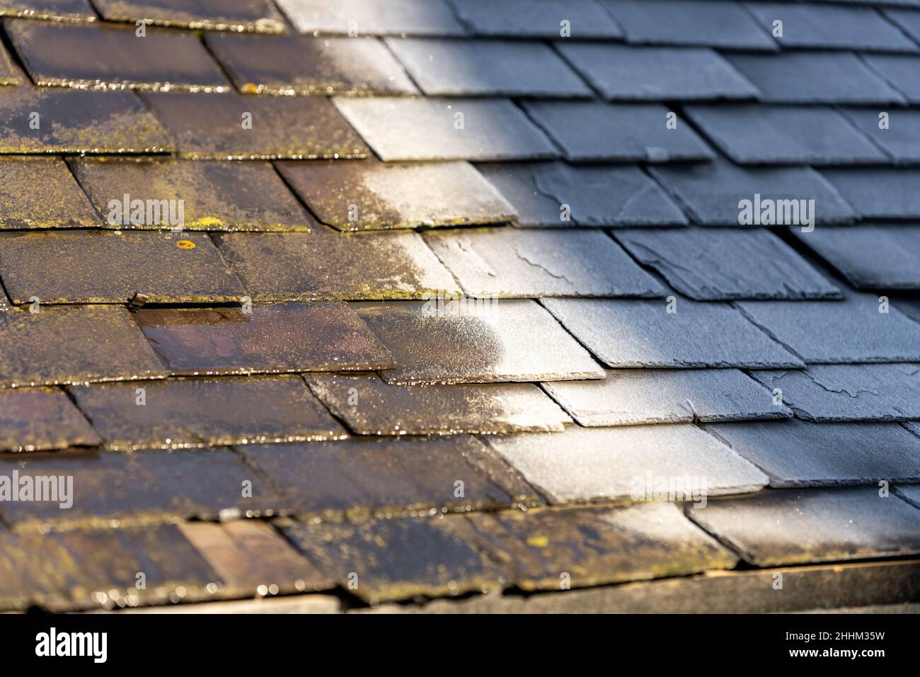 Frost melting on old roof tiles as sun breaks through in the morning ...
