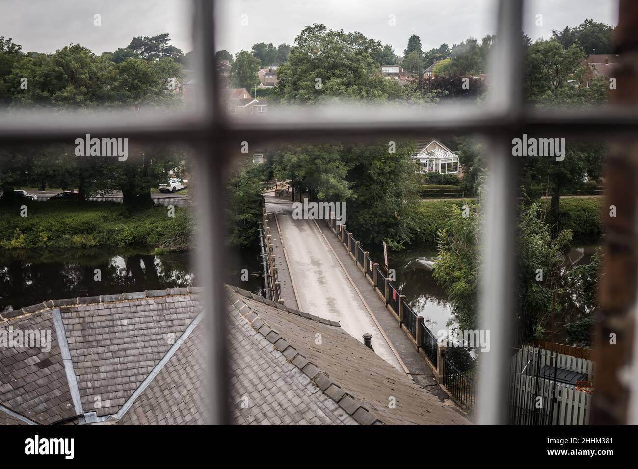 Old historic road bridge crossing river viewed through window from high ...