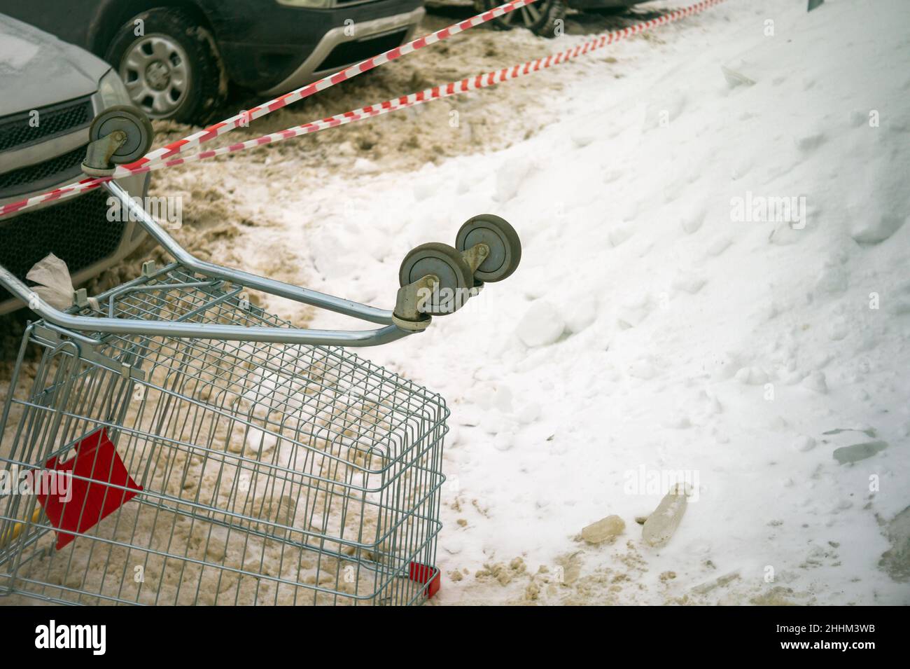 turned over shopping trolley and hazard tape, winter scene Stock Photo ...