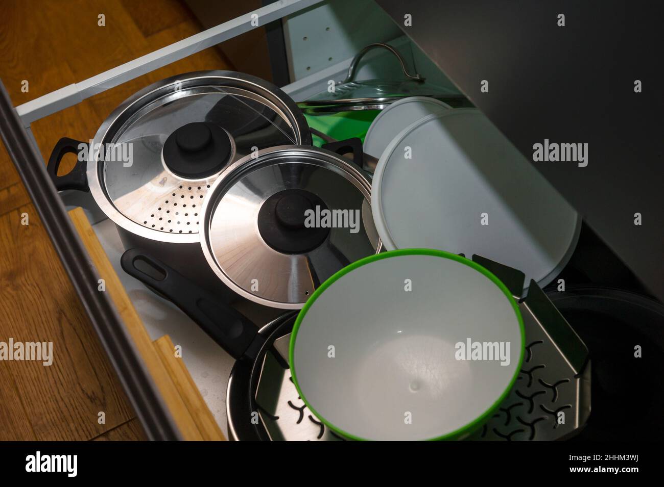 open kitchen drawer with collection of clean dish-ware, indoor shot ...