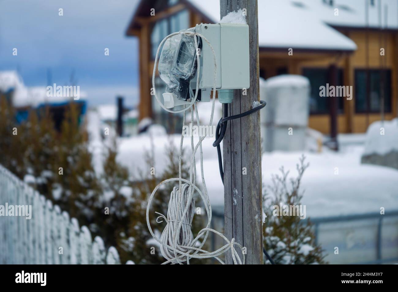 tangled usb wires plugged in outdoor weather protected socket, winter ...