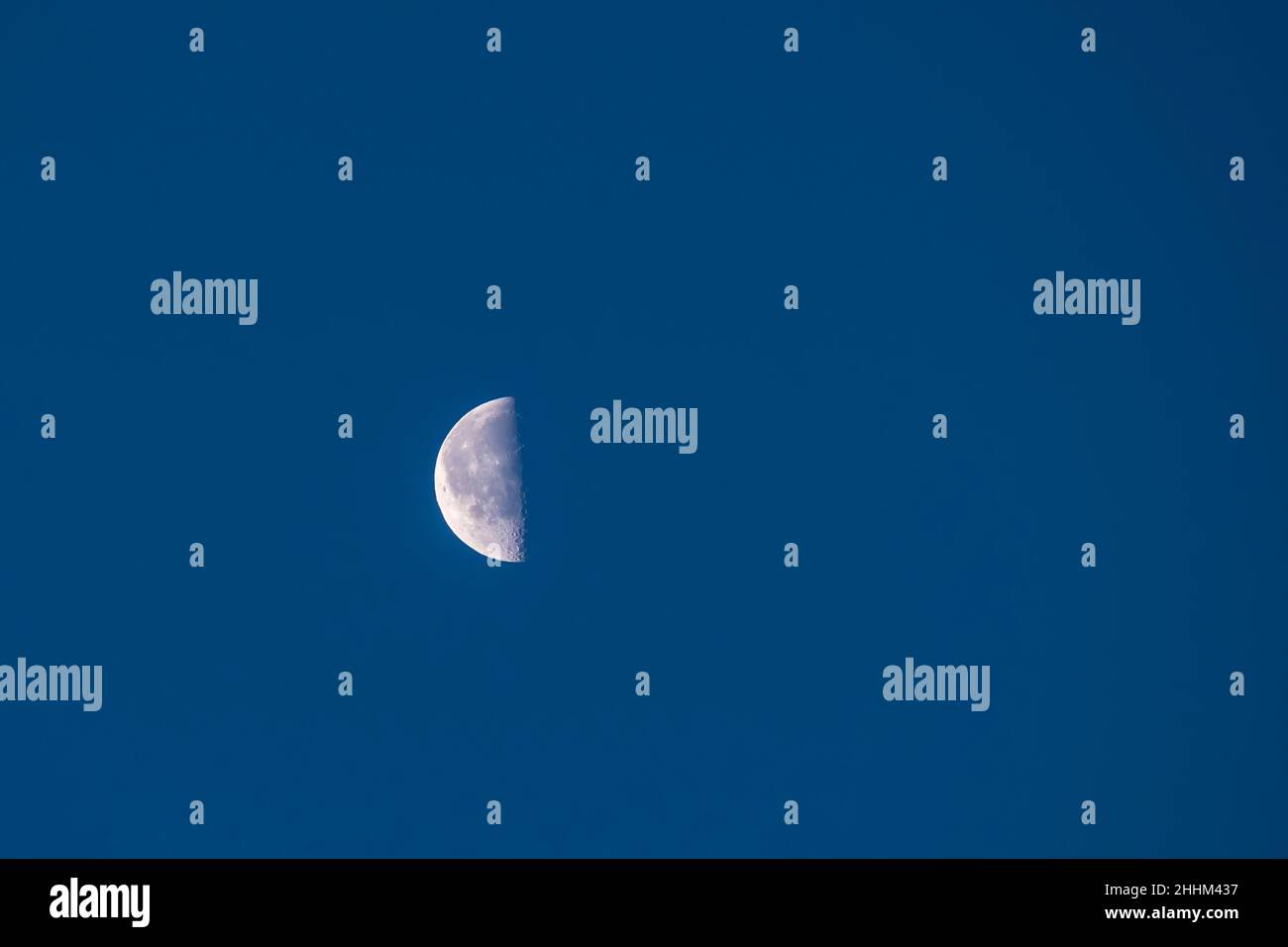 Half moon high against early morning cloudless blue sky Stock Photo - Alamy